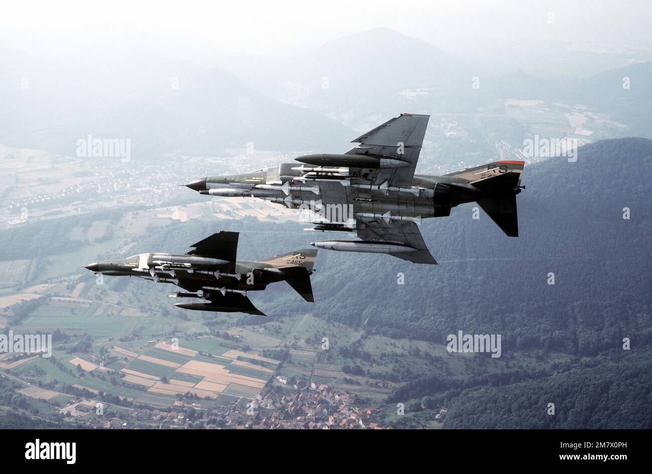 A air-to-air left side view of two F-4E Phantom II aircraft banking to ...