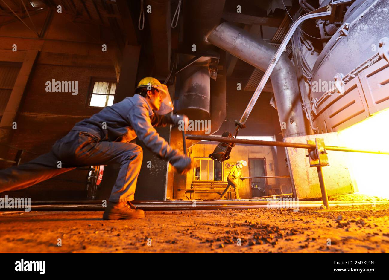 ZHANGYE, CHINA - JANUARY 10, 2023 - A smelting worker observes the ...