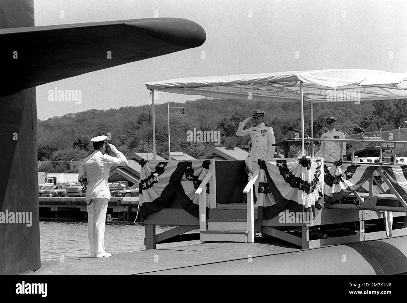 The officer of the deck salutes as CDR William L. Norris, executive ...