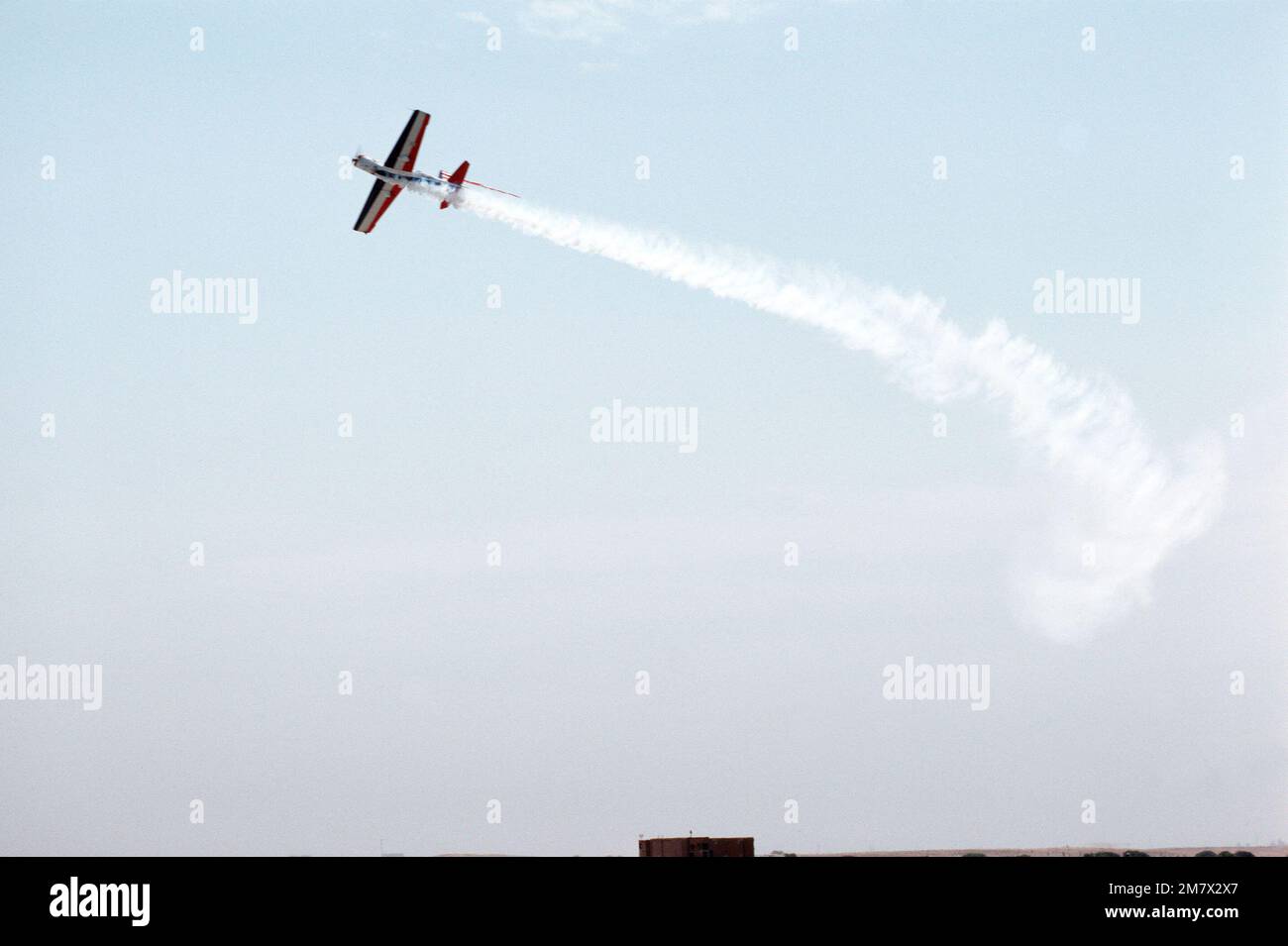 A small aircraft performs aerial stunts for guests attending the air ...