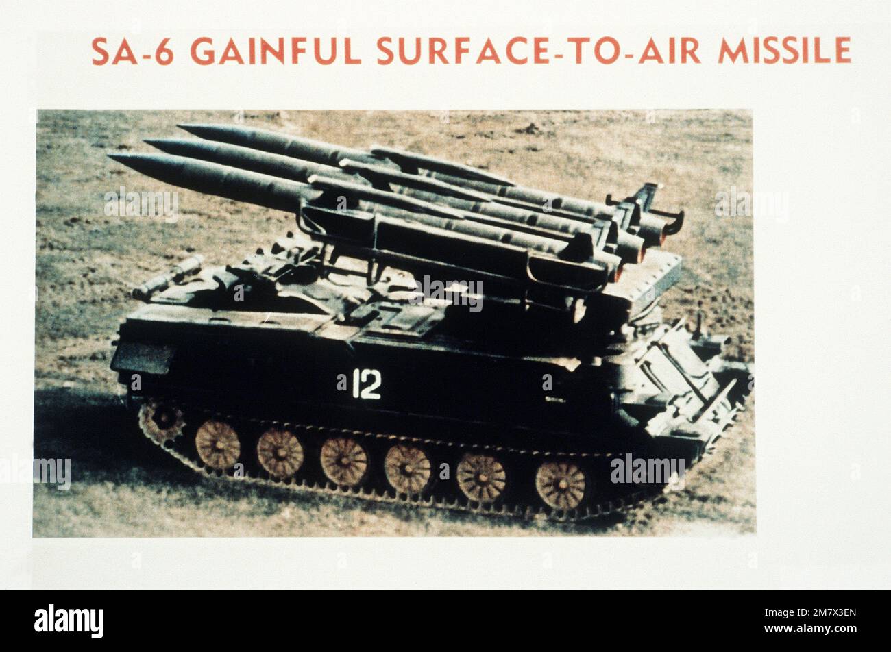 A left side view of a tracked transporter/launcher carrying three ...