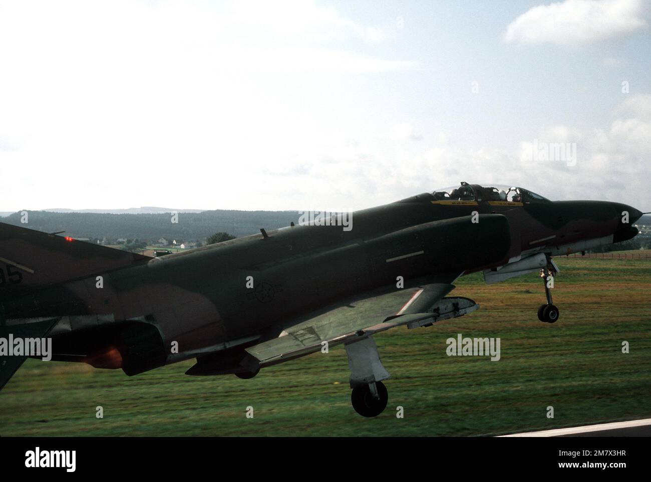 A view of an F-4G Phantom II aircraft taking off. The aircraft is from ...