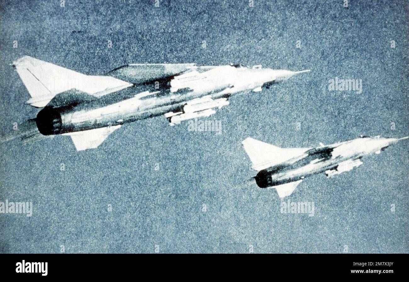 A right side view of two Soviet MiG-23-MF Flogger-B aircraft in flight ...