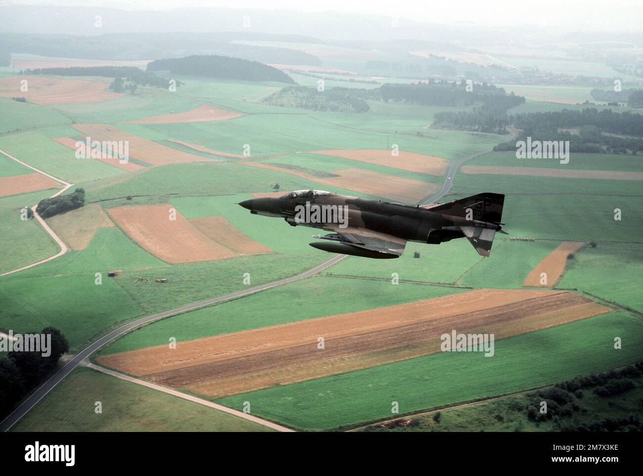 A view of an F-4E Phantom II aircraft banking to the right. The ...
