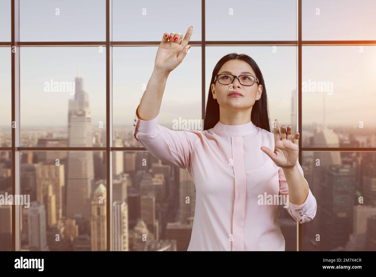 Portrait of young asian woman is interacting with invisible virtual ...