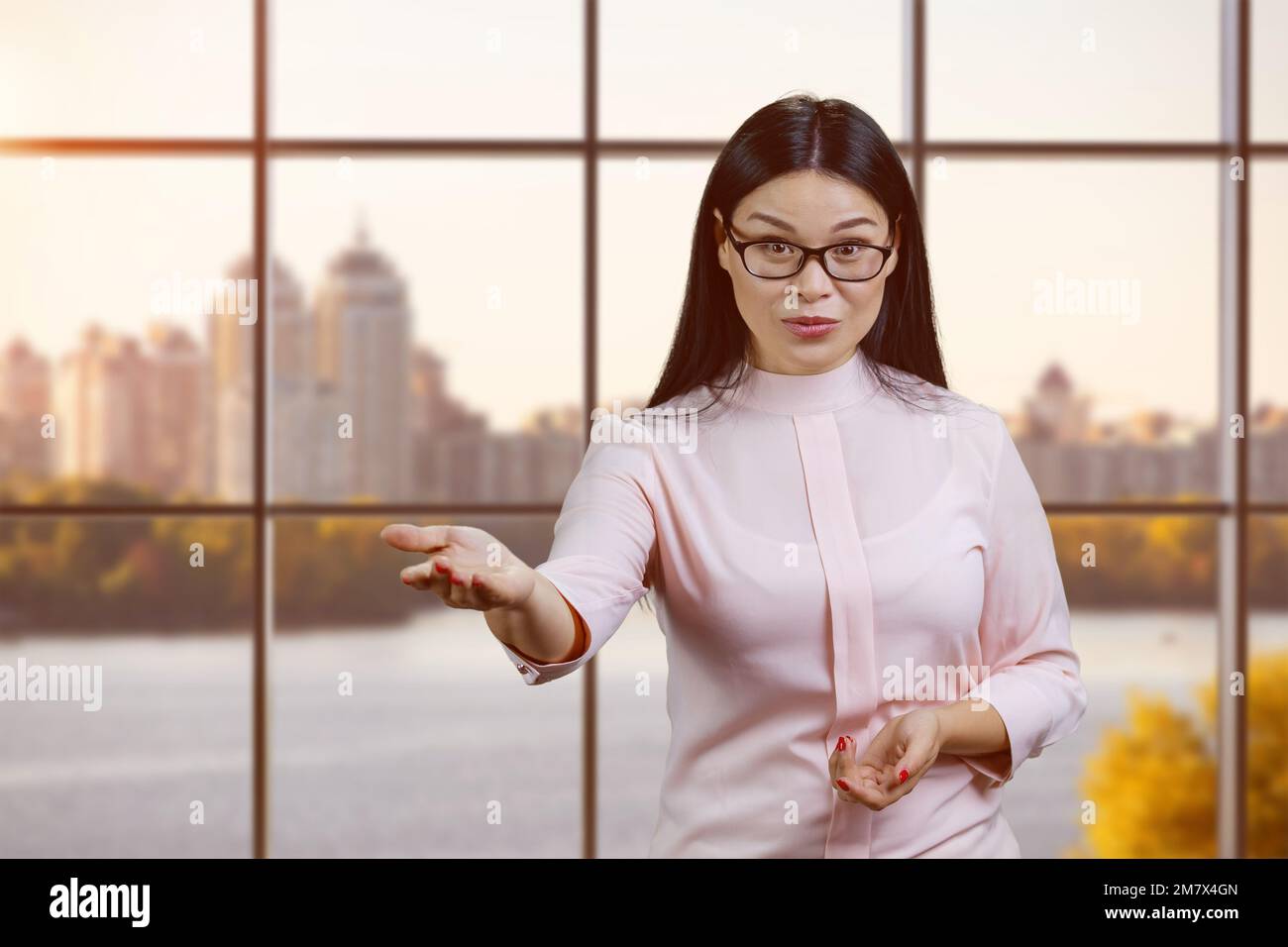 Portrait of a young asian woman is explaining herself. Checkered ...
