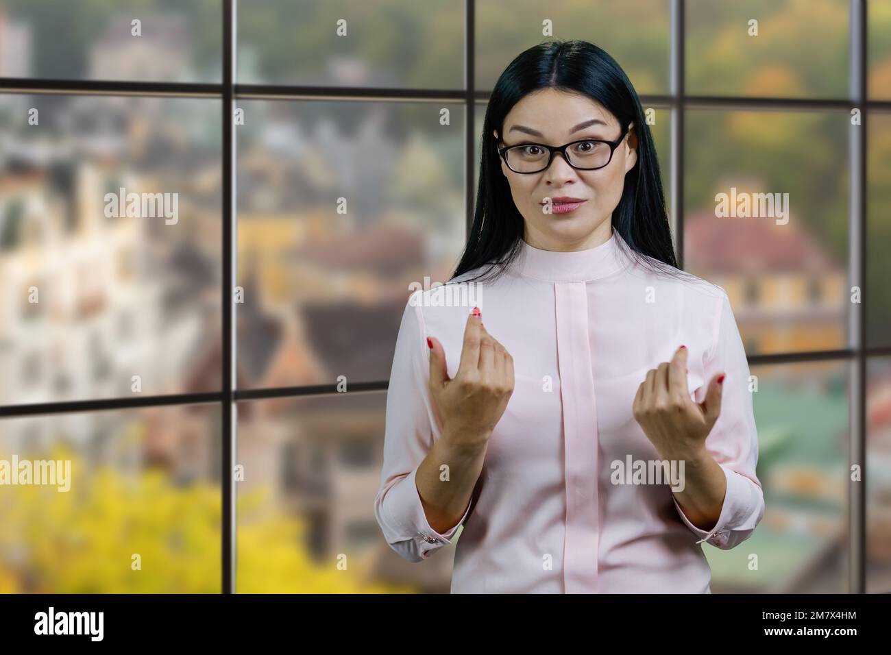 Portrait of a young surprised asian woman is gesturing with hands ...