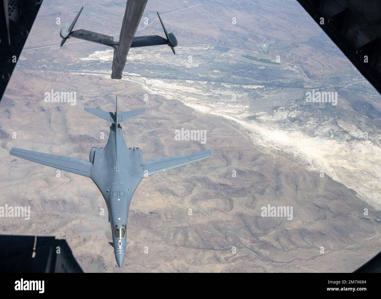 A U.S. Air Force B-1 Lancer flies below a KC-10 Extender over Northern ...