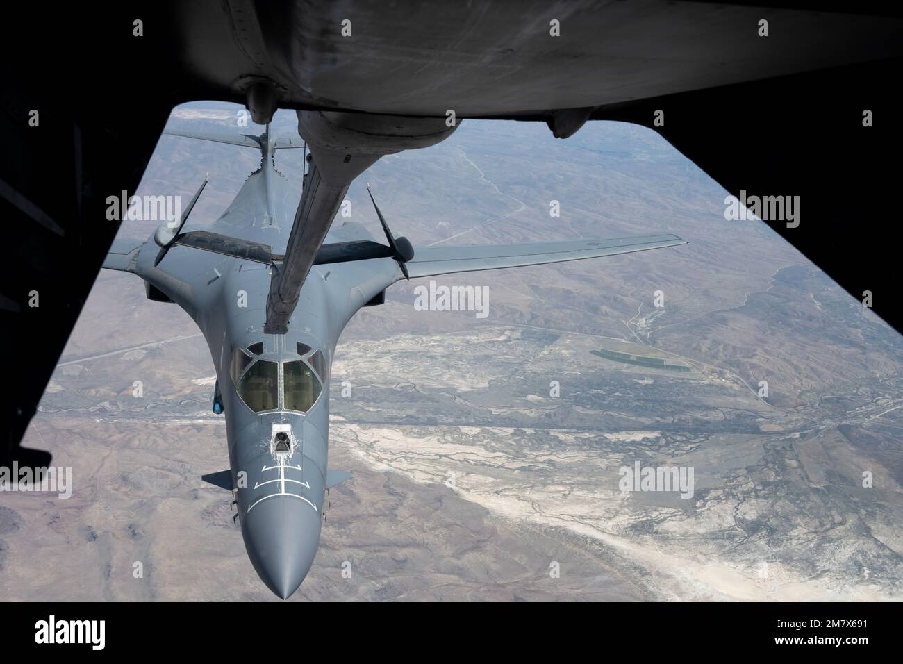 A U.S. Air Force B-1 Lancer flies below a KC-10 Extender over Northern ...
