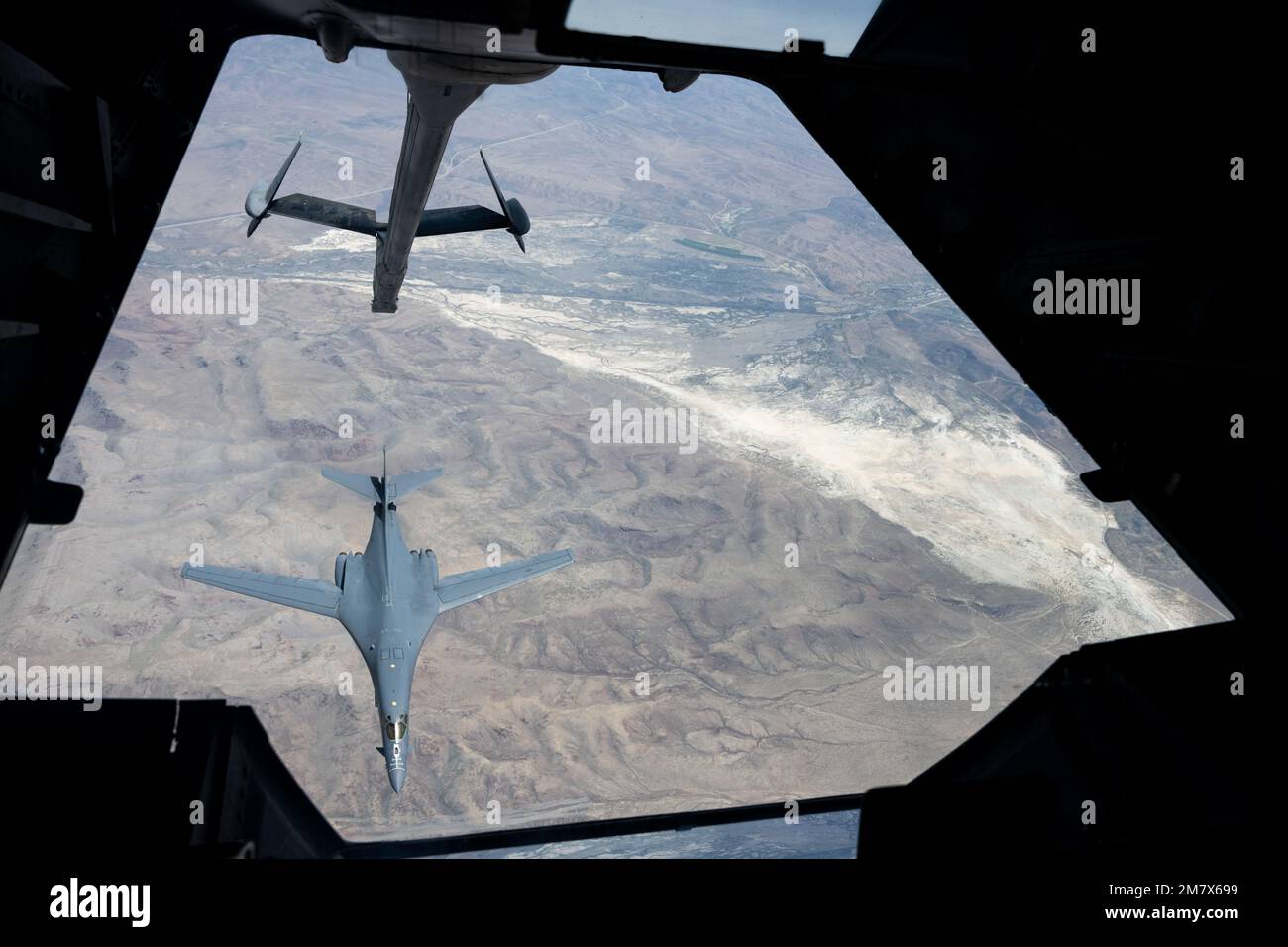 A U.S. Air Force B-1 Lancer flies below a KC-10 Extender over Northern ...