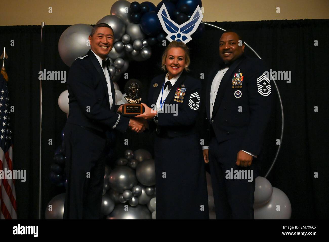 Chief Master Sgt. Kara West (center), 75th Logistics Readiness Squadron, poses with Col. Peter ...