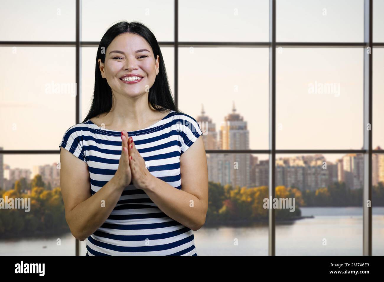Portrait of a young asian woman is praying for something. Checkered ...