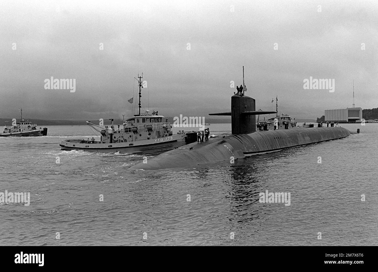 A port bow view of crewmen on the sail of the nuclear-powered strategic ...