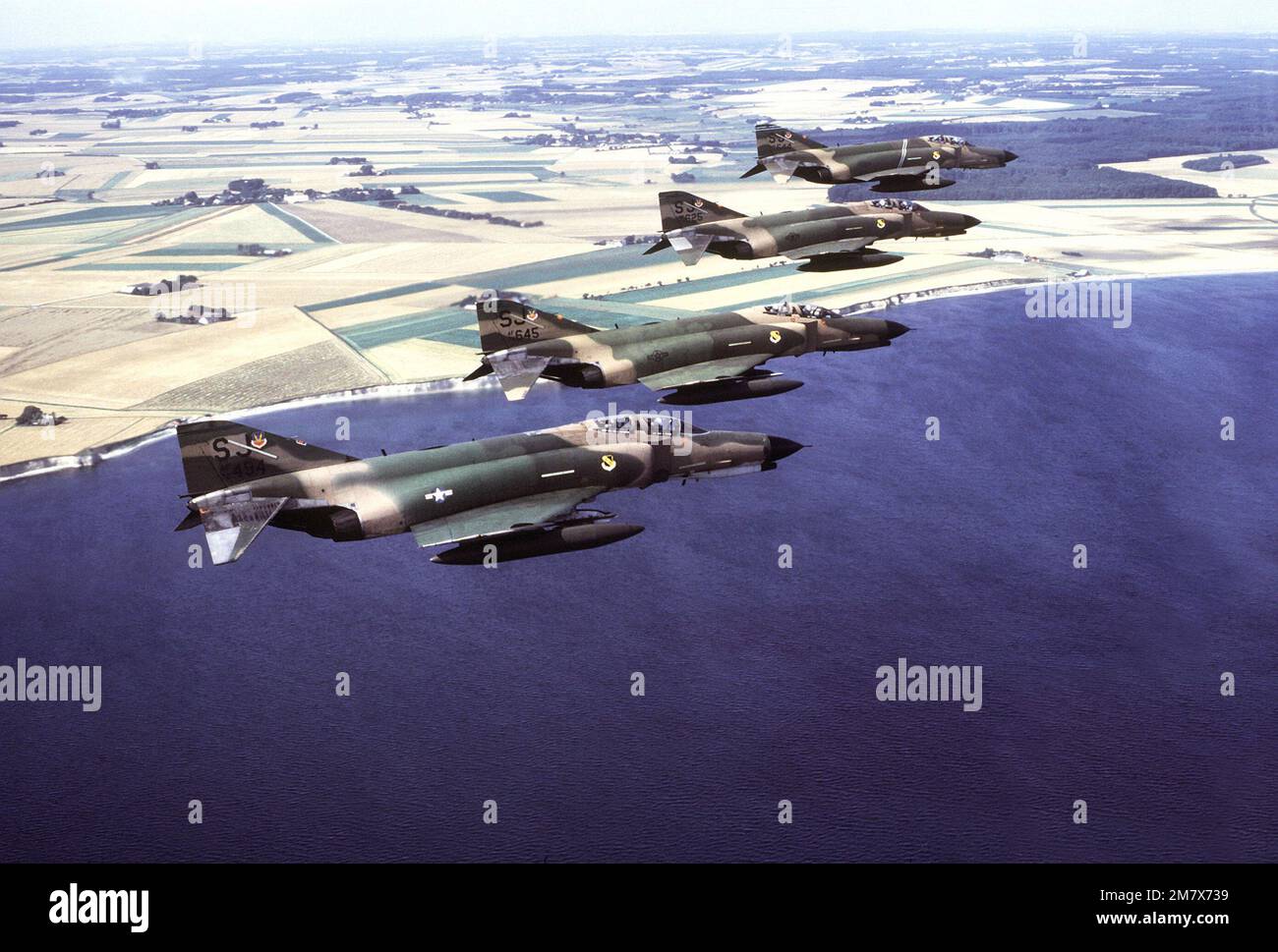 An air-to-air right side view of four F-4E Phantom II aircraft from the ...