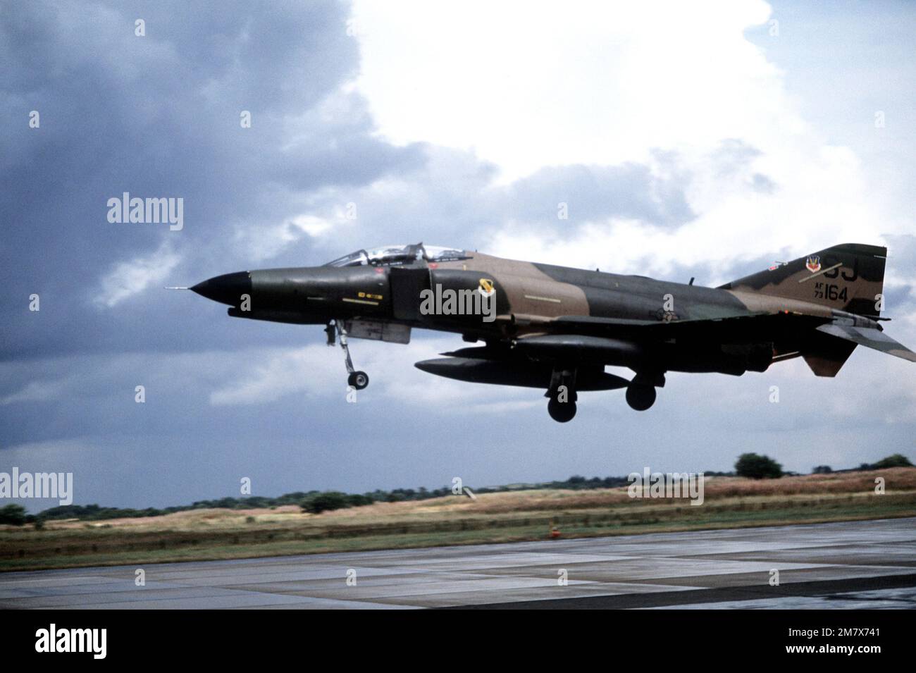 A left side view of an F-4E Phantom II aircraft taking off during ...