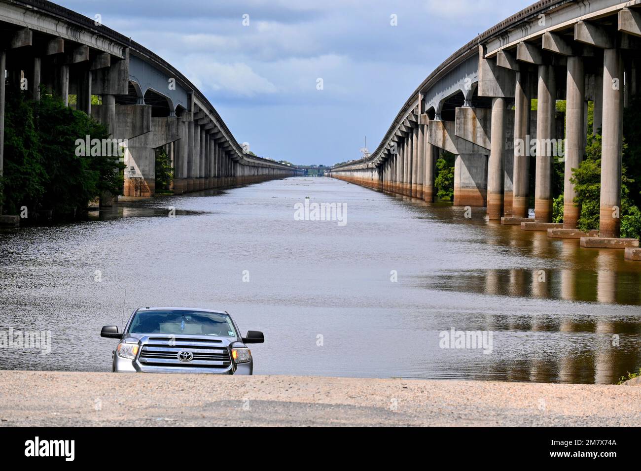 A Toyota car on a slope with river between two bridges in the ...