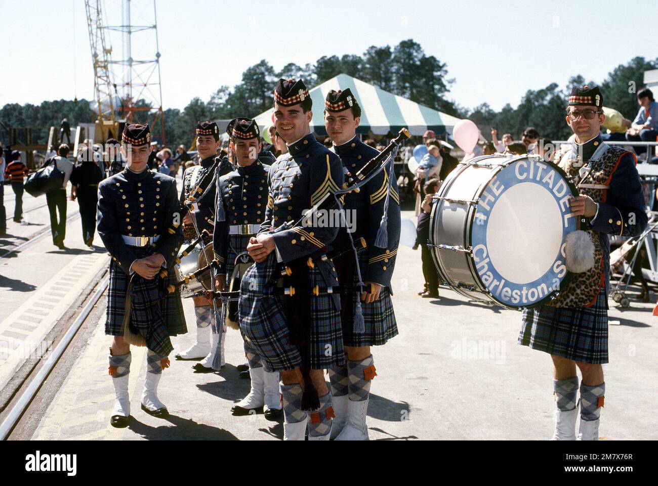 A band dressed in traditional Scottish uniforms awaits the return of ...