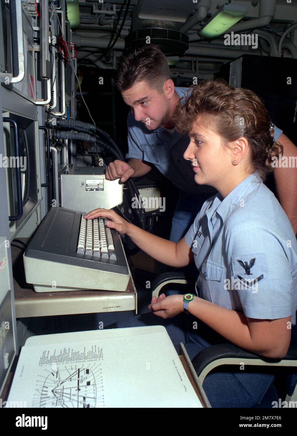 A female member of a fleet replacement squadron monitors a computer ...