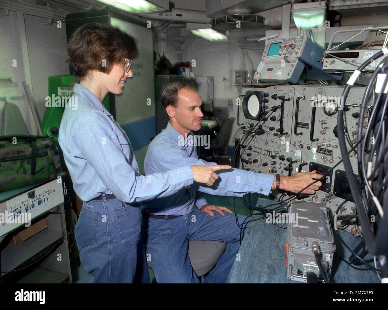 A female member of a fleet replacement squadron assists with testing ...