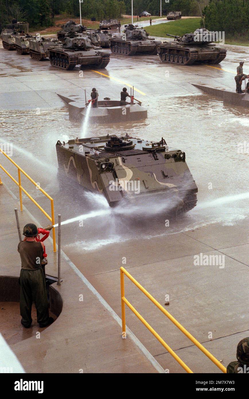 An M-113 armored personnel carrier is washed at the tank wash ...