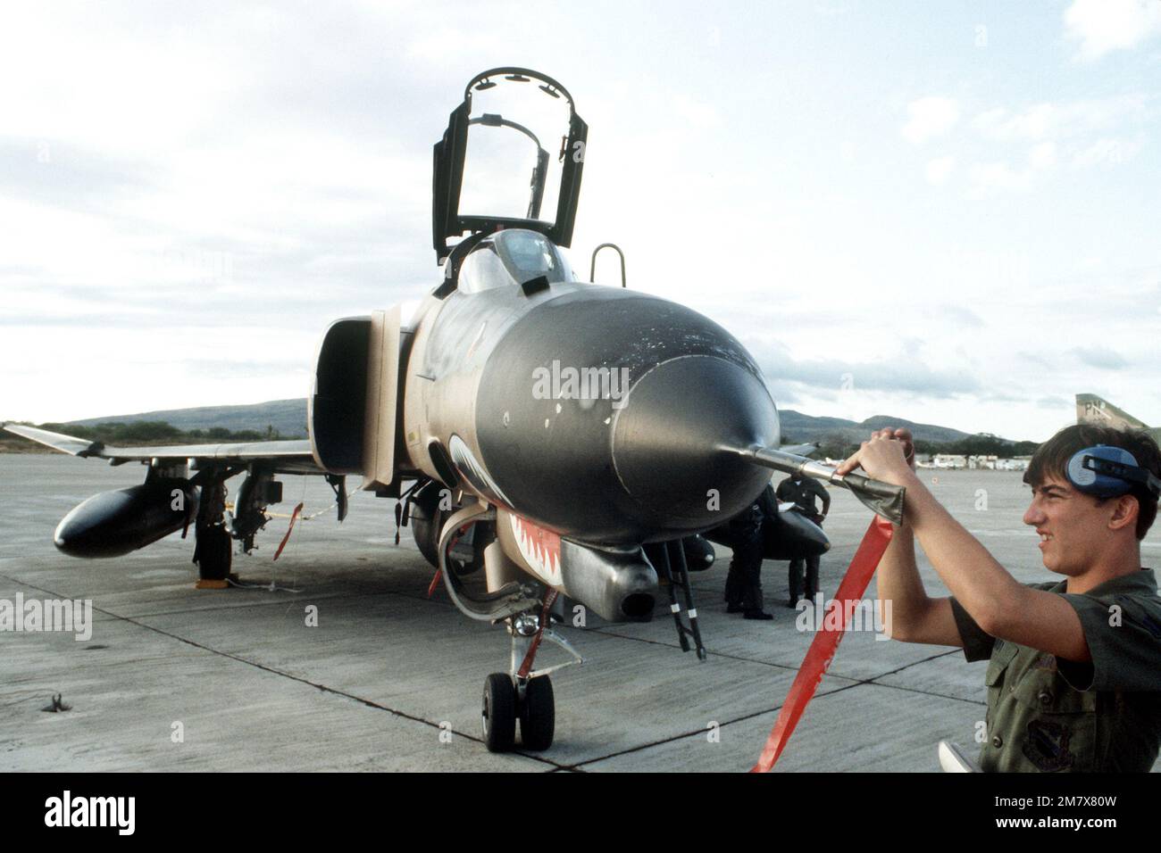 A crew chief covers the pitot tube of an F-4 Phantom II aircraft during ...