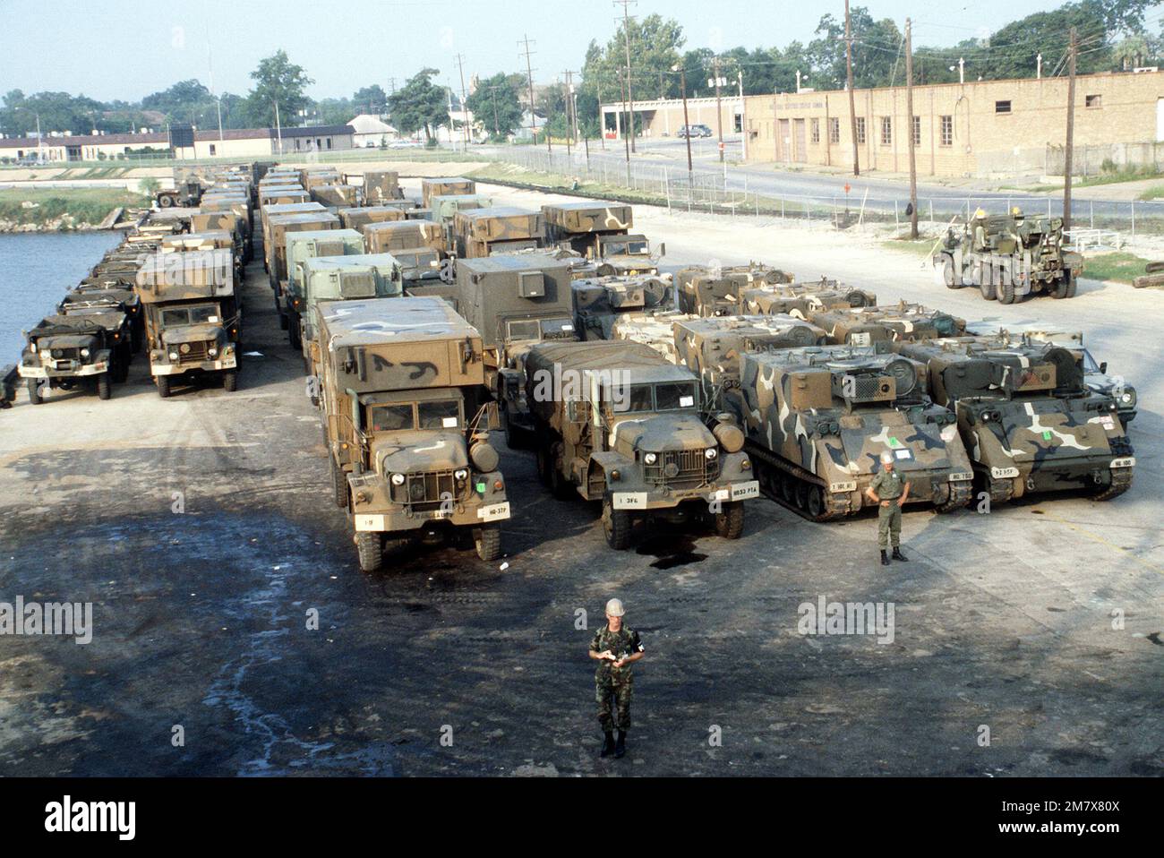 Army vehicles in the staging area prior to being loaded aboard a ...