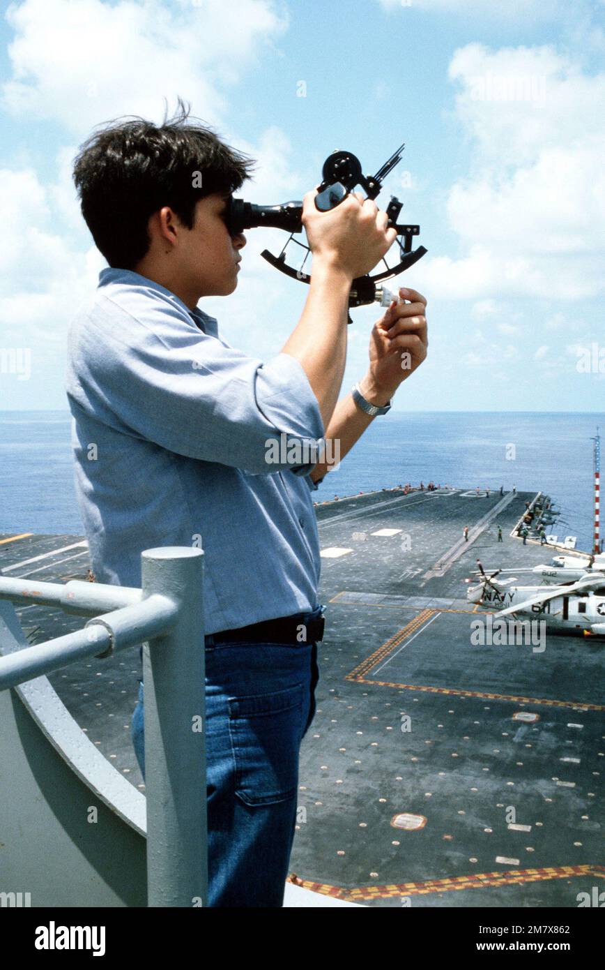 A crewman uses a sextant (a navigational device) to plot a course for ...
