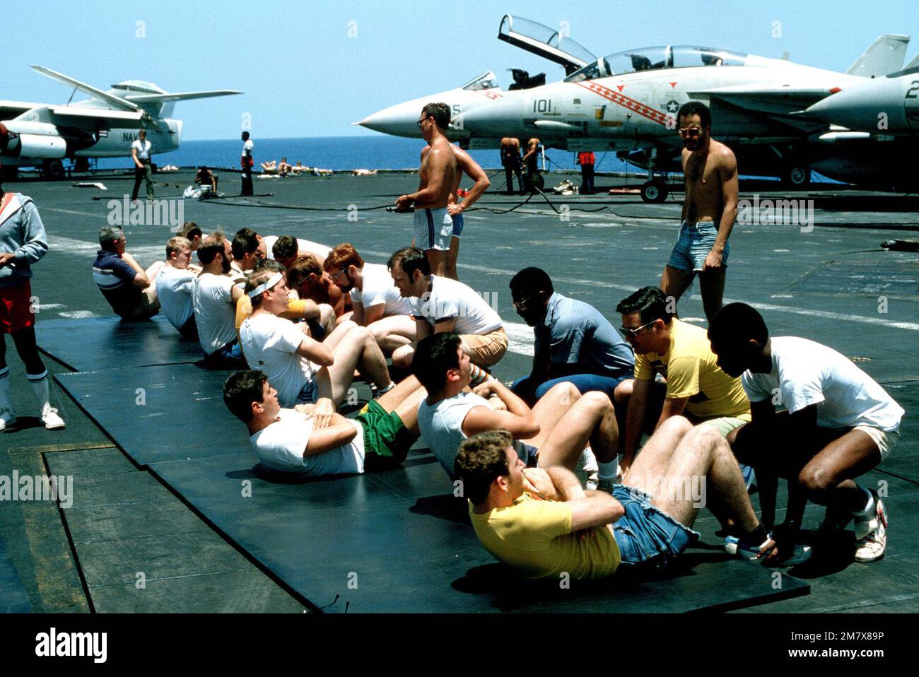 Physical training exercises take place on the flight deck of the ...
