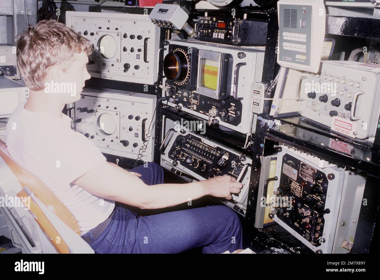 A crewman operates the SPA-66 radar scope in the combat information ...