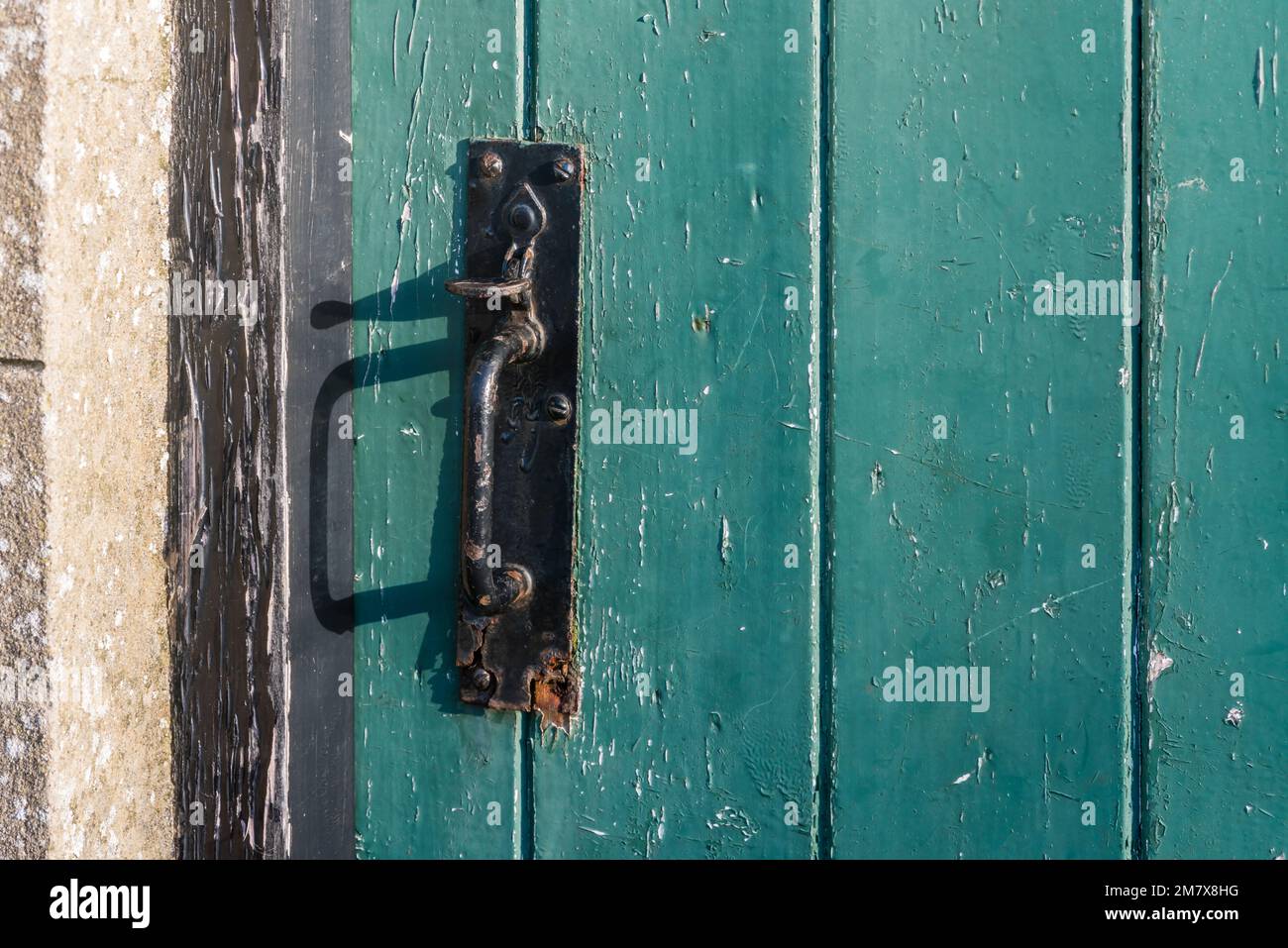 A traditional metal steel thumb catch on a shed barn workshop door ...
