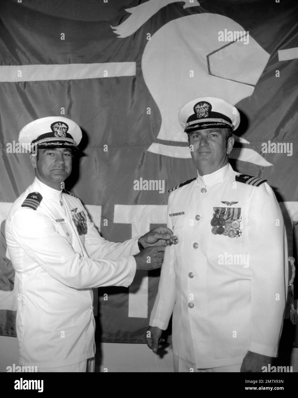 CDR David T. Wagner (left) pins the command badge on the new commanding ...