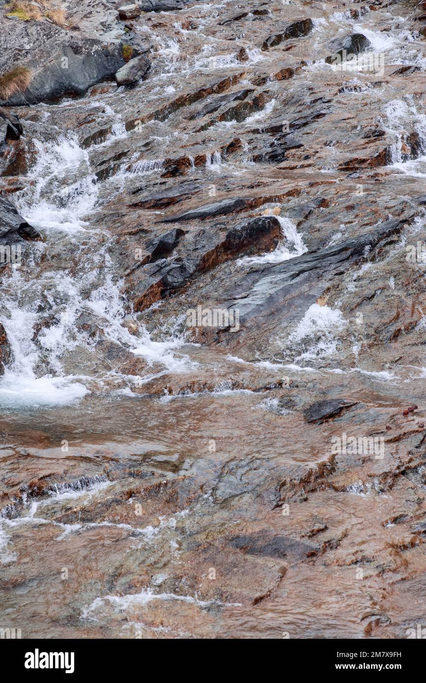 Beautiful texture of black-chocolate brown granite washed by running ...