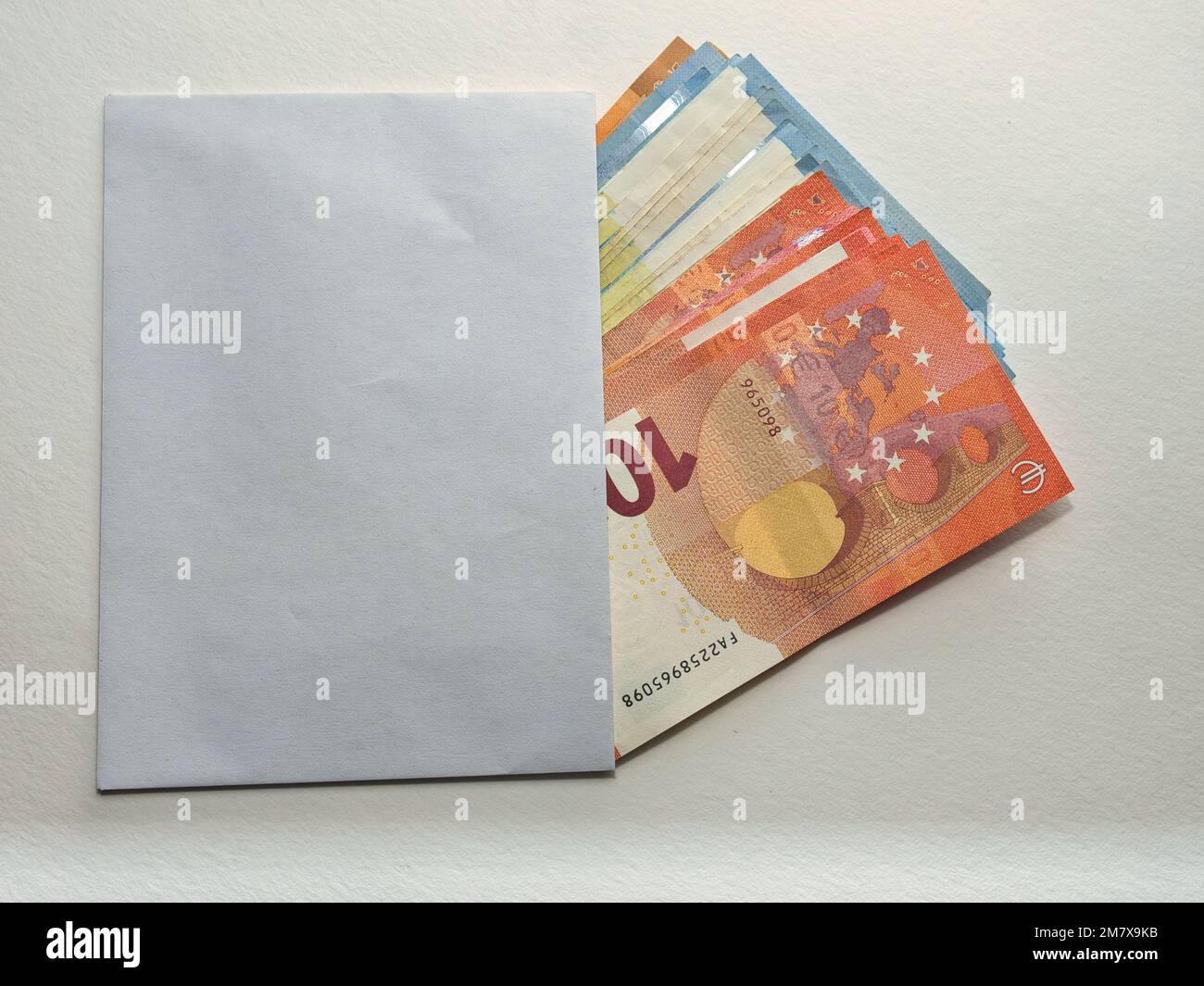 A Banknotes sticking out of an envelope on a white background Stock ...
