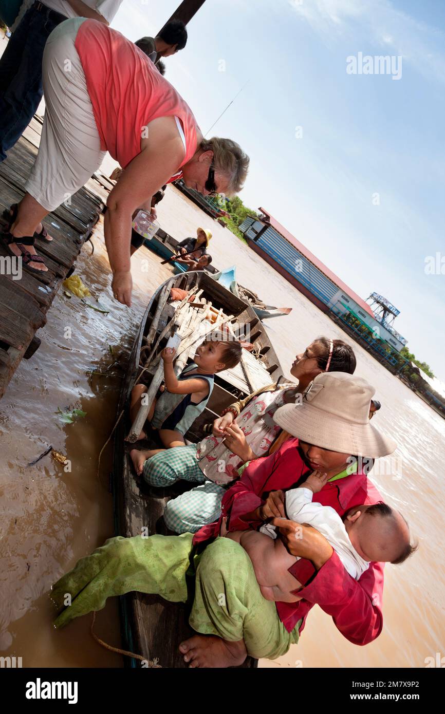 Chong Kneas, Cambodia-August 6, 2009: Tourists give candy to the ...
