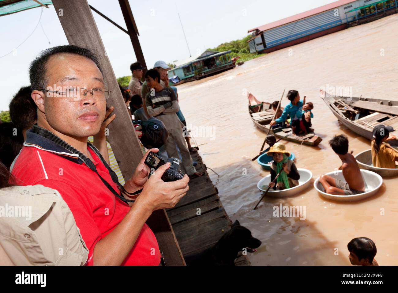 Chong Kneas, Cambodia-August 6, 2009: Tourists give candy to the ...