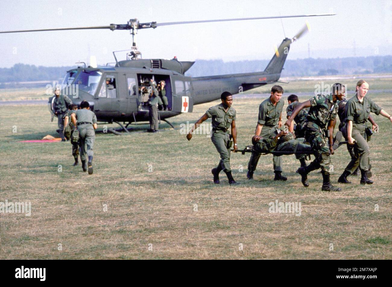 Medics rush a simulated combat casualty from a UH-1 Iroquois MEDEVAC ...