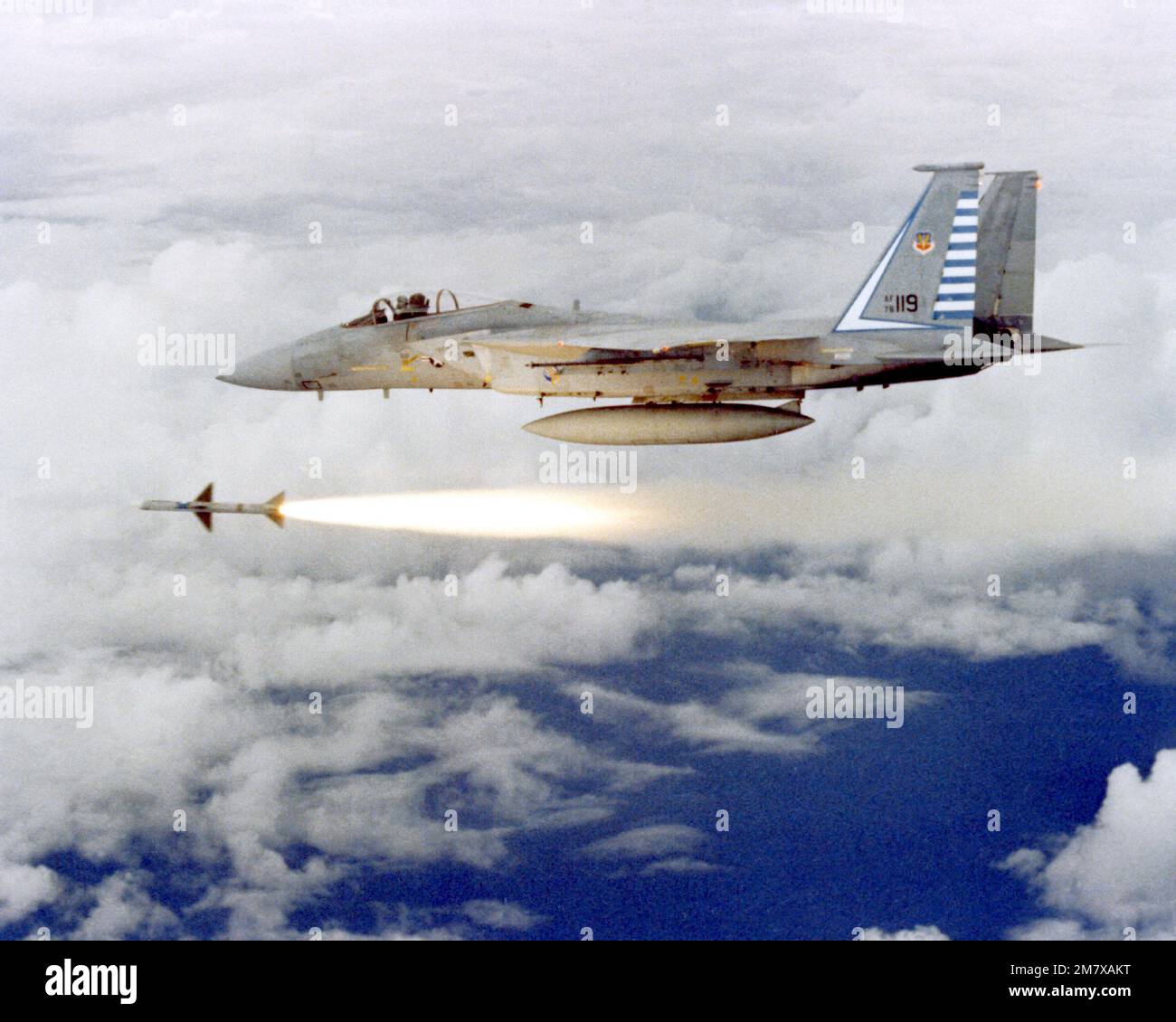 An air-to-air left side view of an F-15 Eagle aircraft firing an AIM-7 ...