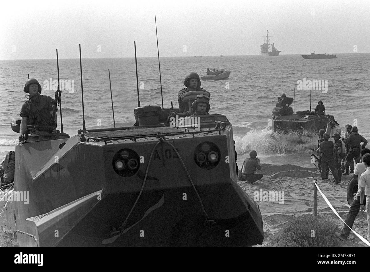 An LVTC-7 tracked command vehicle comes ashore as U.S. Marines ...