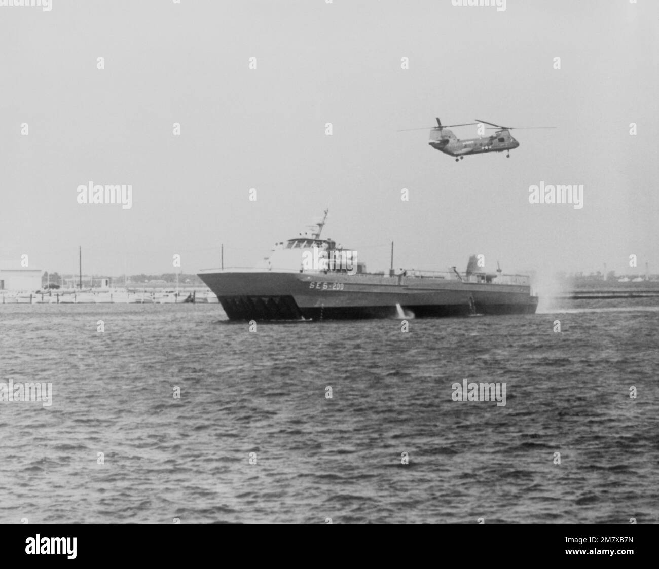 A view of the experimental surface effect ship SES 200, with an H-46 ...