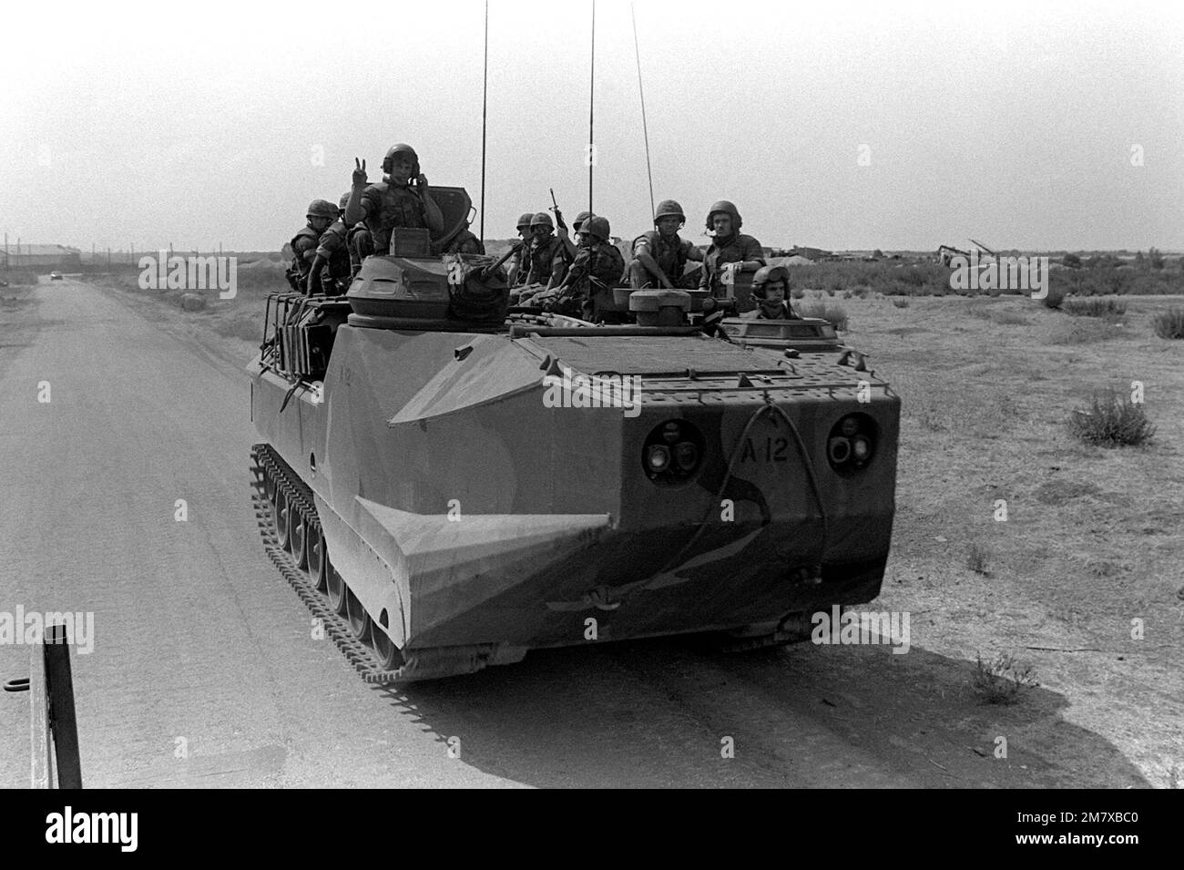 A U.S. Marine LVTP-7 tracked landing vehicle moves along the perimeter ...