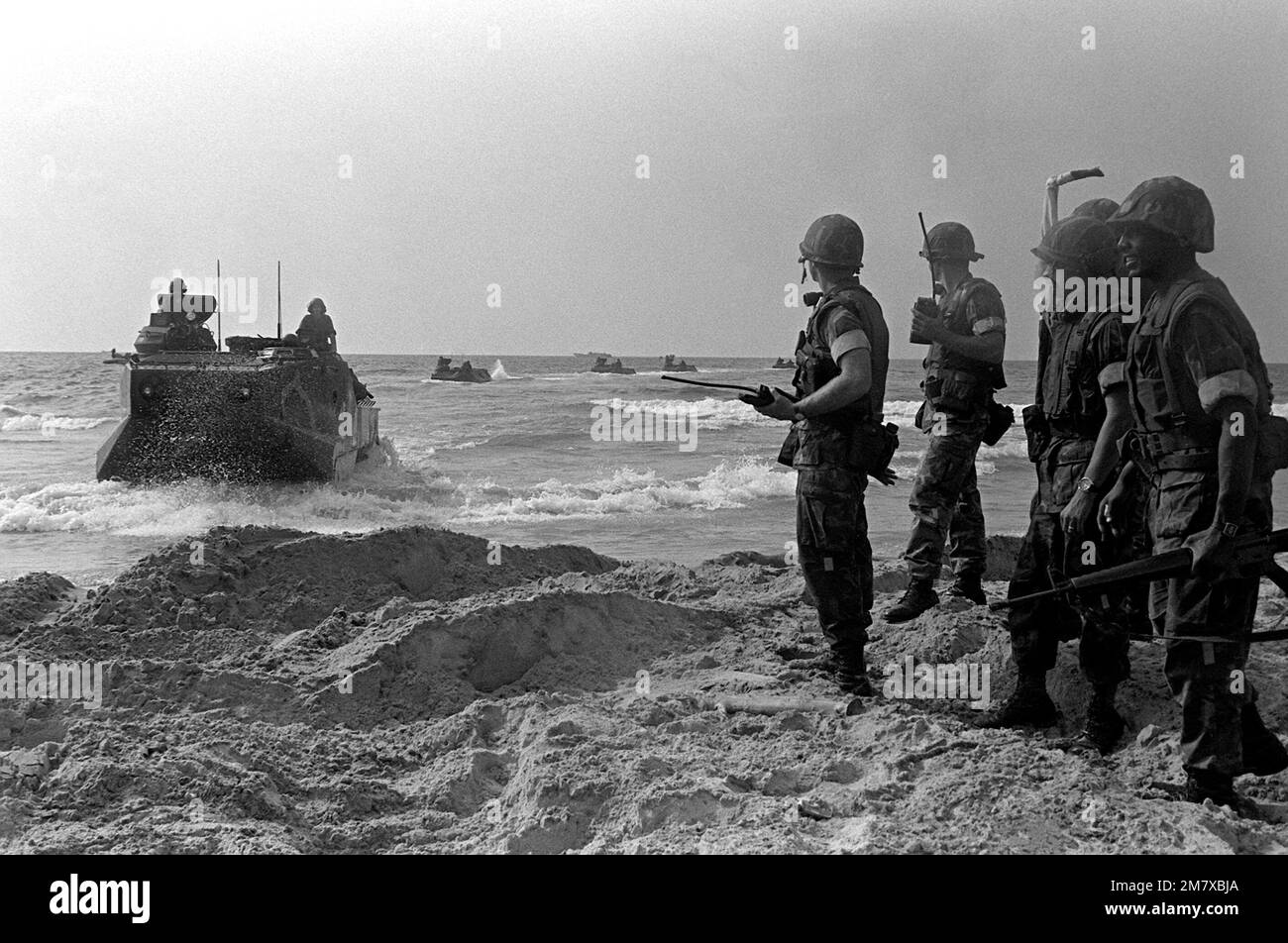 Beachmasters watch as a Marine LVTP-7 personnel tracked landing vehicle ...