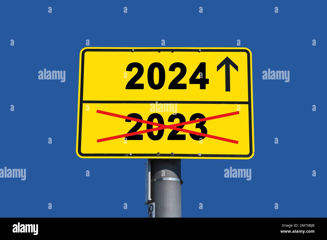 Yellow sign with black lettering. Below the word 2023 crossed out in ...