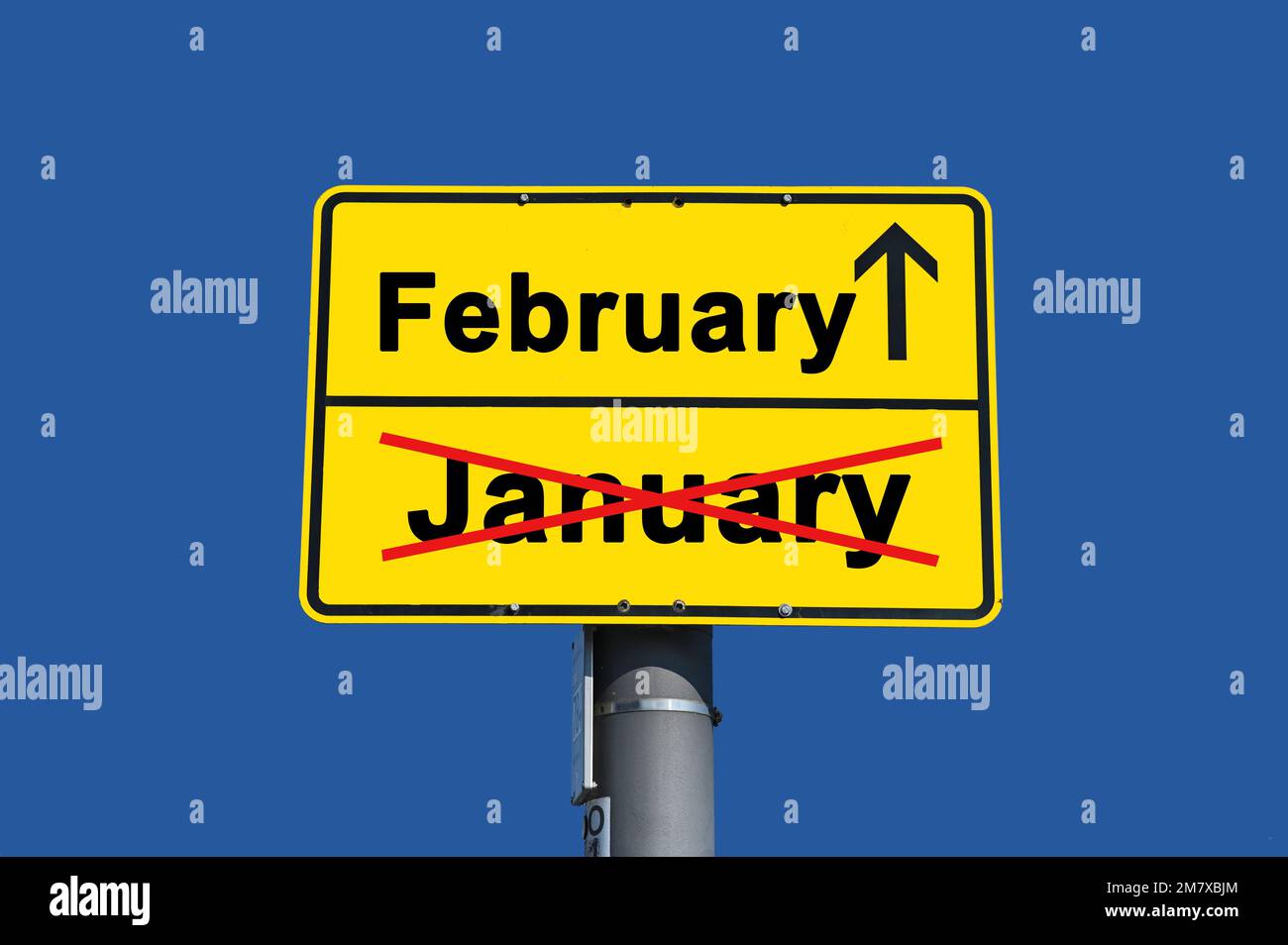 Yellow sign with black lettering. Below the word January crossed out in ...