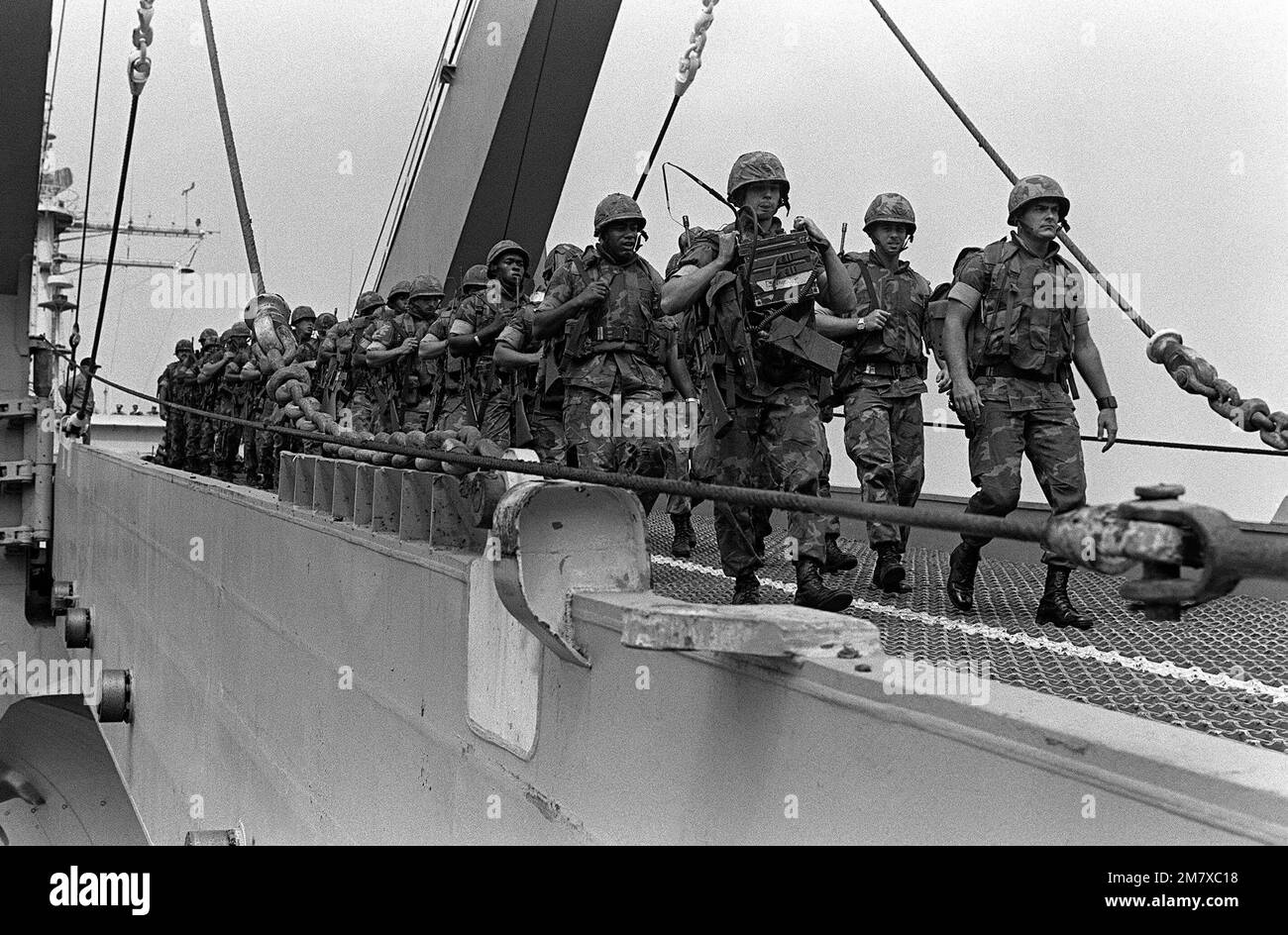 Marines from the 32nd Marine Amphibious Unit walk down the bow ramp of ...