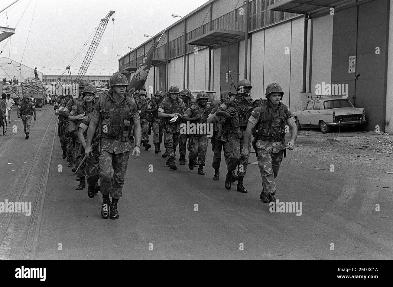 Marines from the 32nd Marine Amphibious Unit walk down the pier after ...