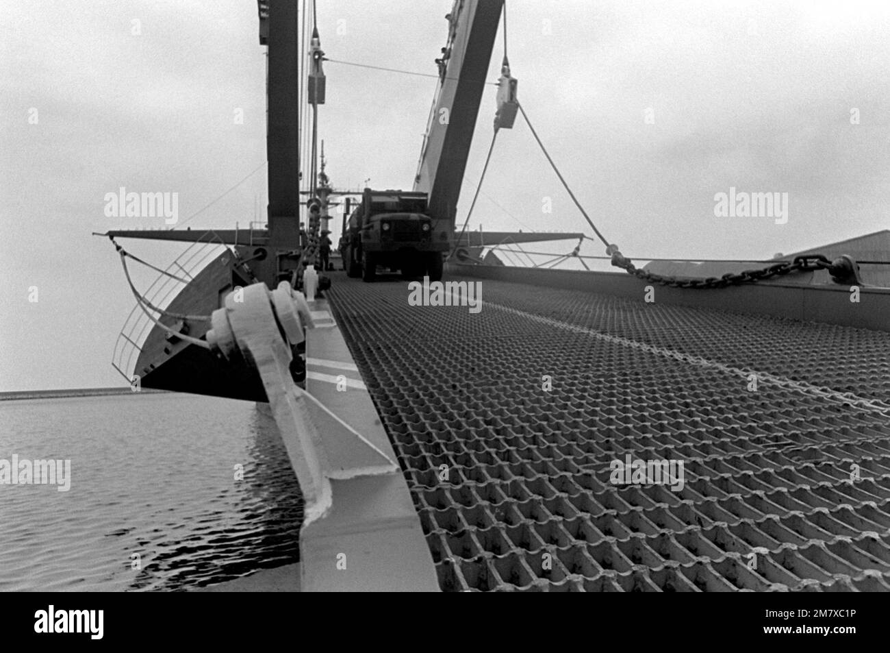 Marine vehicles roll down the bow ramp of the tank landing ship USS ...