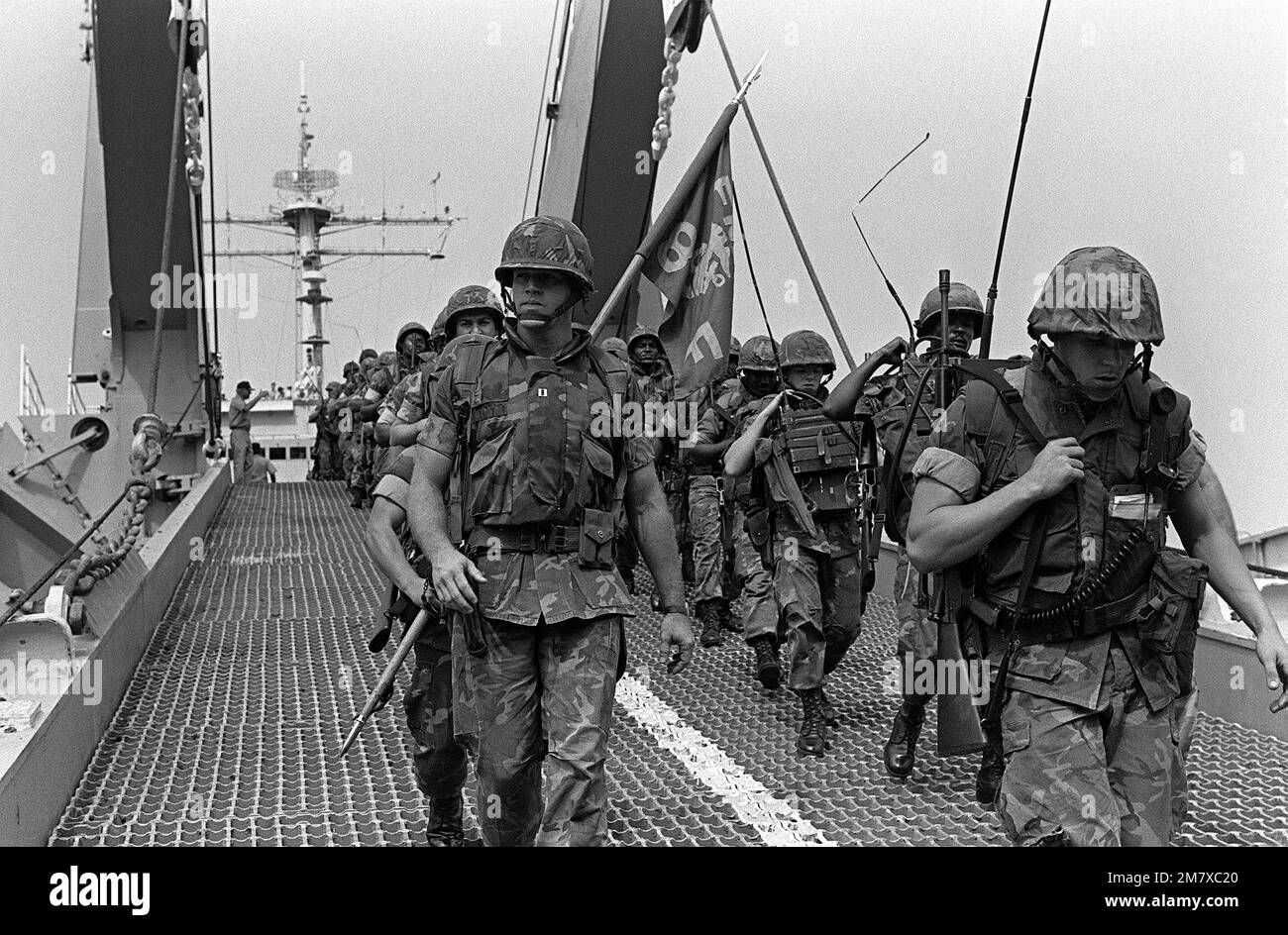 Marines from the 32nd Marine Amphibious Unit walk down the bow ramp of ...