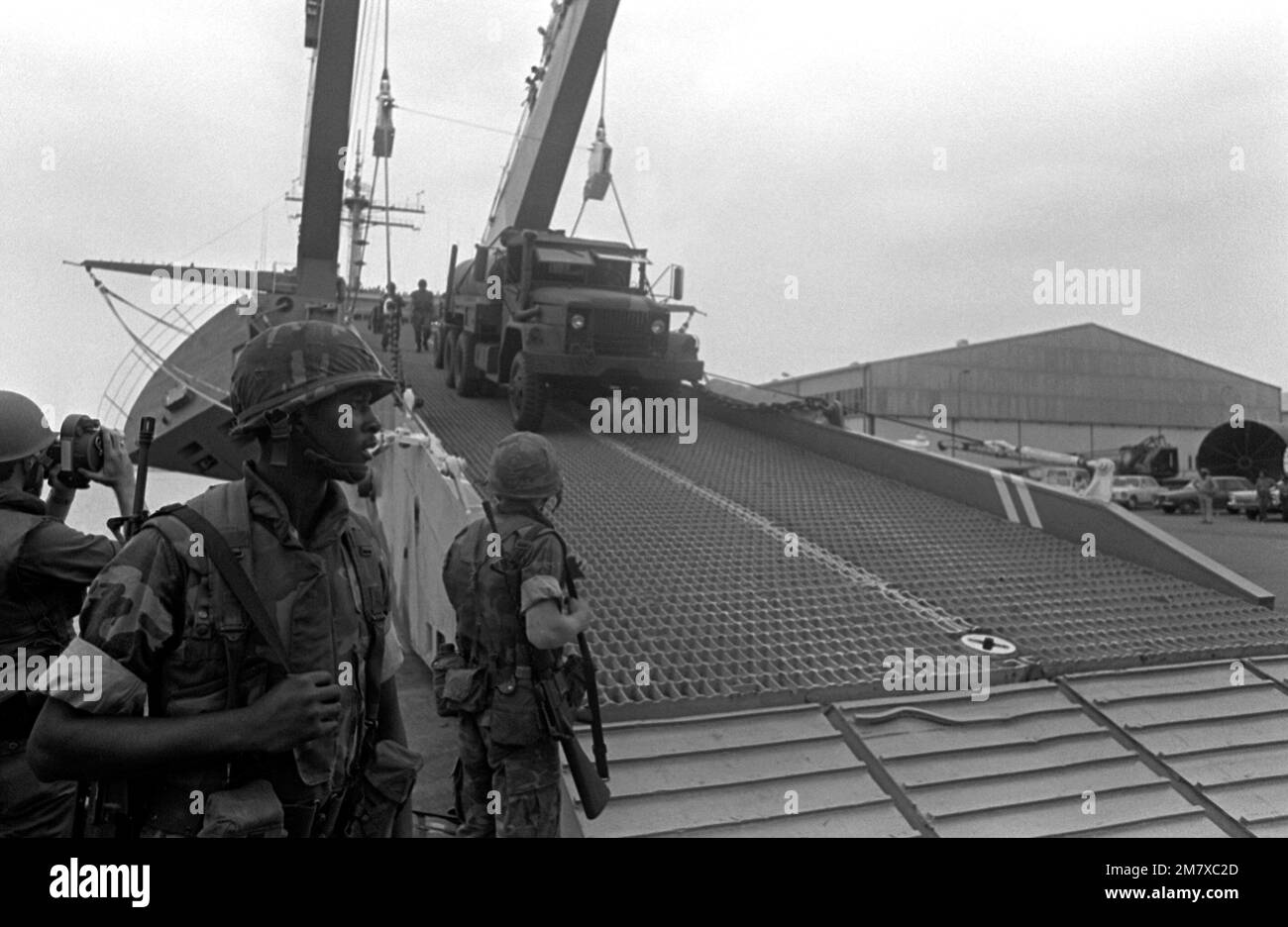 Marine vehicles roll down the bow ramp of the tank landing ship USS ...