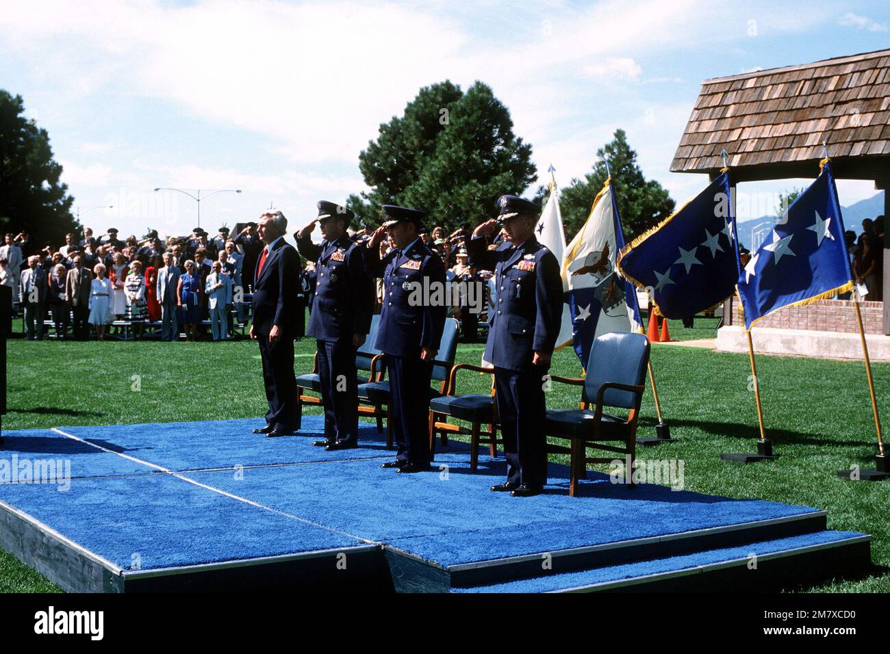 Standing at attention while reviewing the color guard during the ...