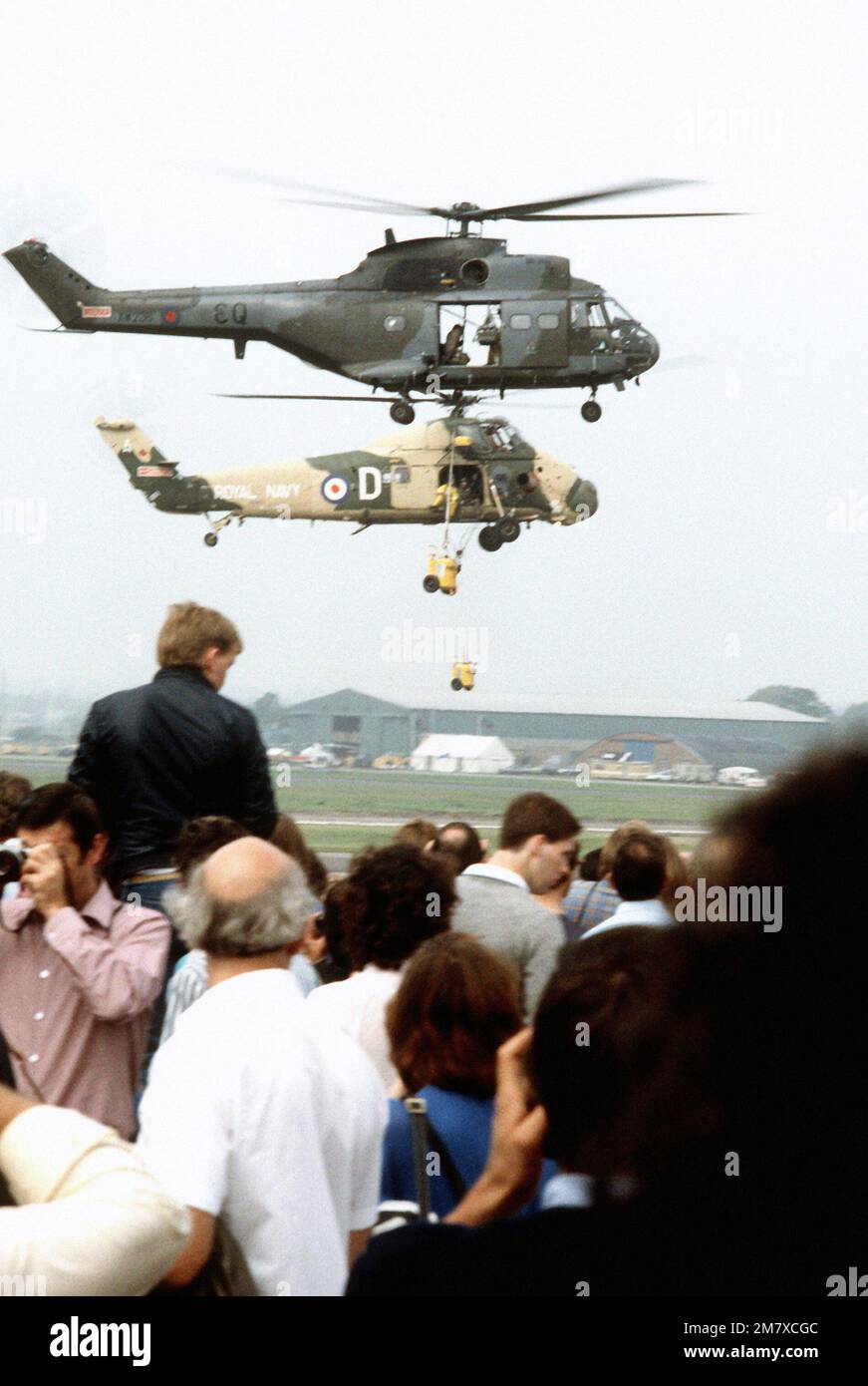 A right side view of two British Royal Navy helicopters on a ...